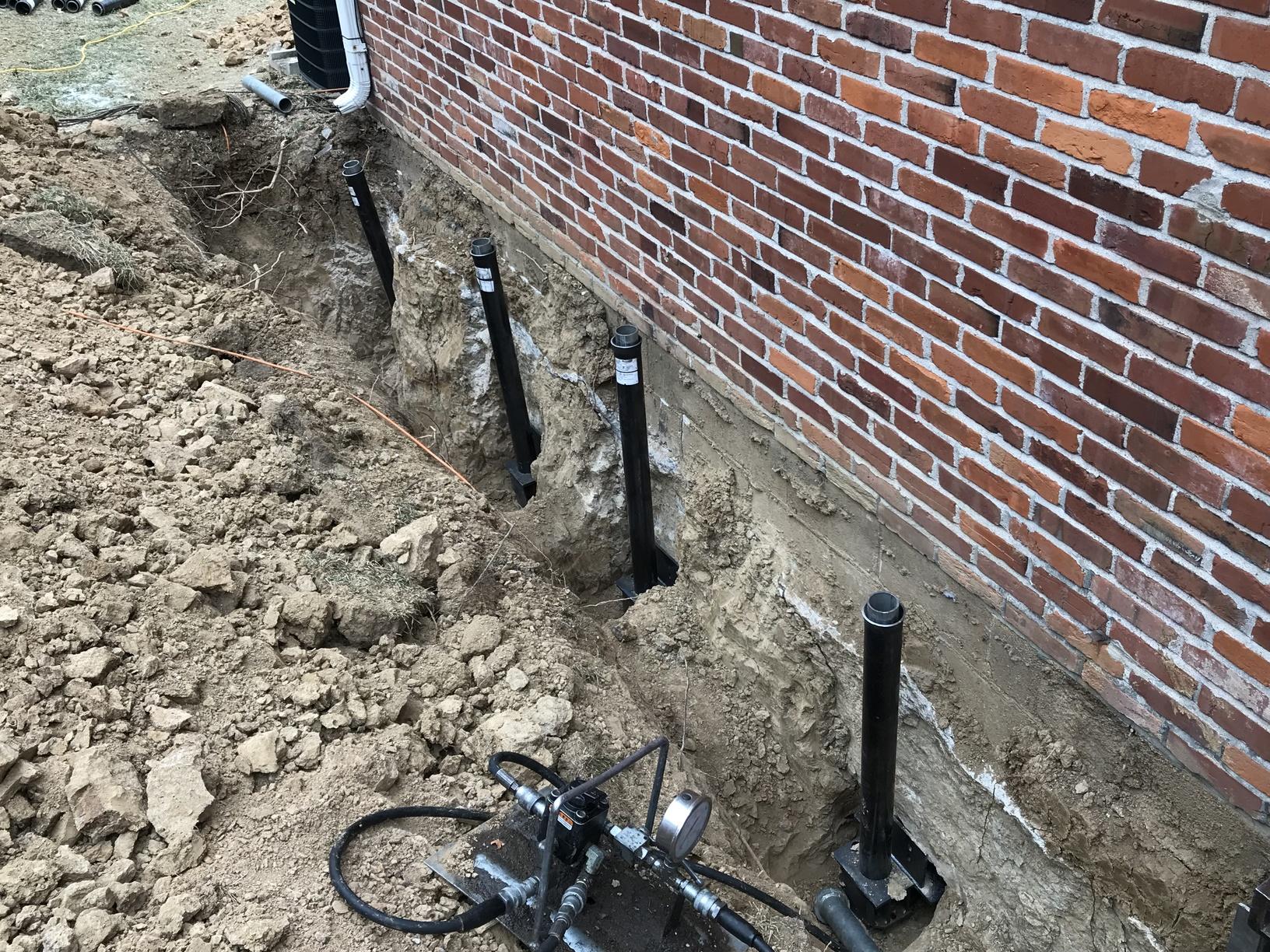Foundation Repair - Exterior Piering - First pier sections set with ...