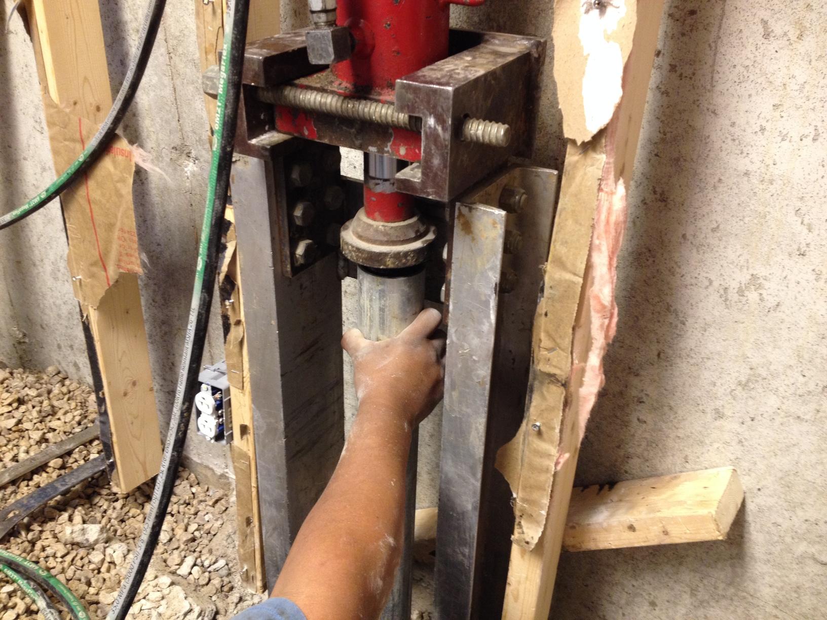 Foundation Repair - Inside Basement Piering - 1st Pier Tube Installed