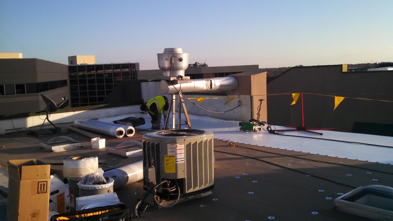 Downtown Greenville Commercial Roofing Project - Crew fastening TPO